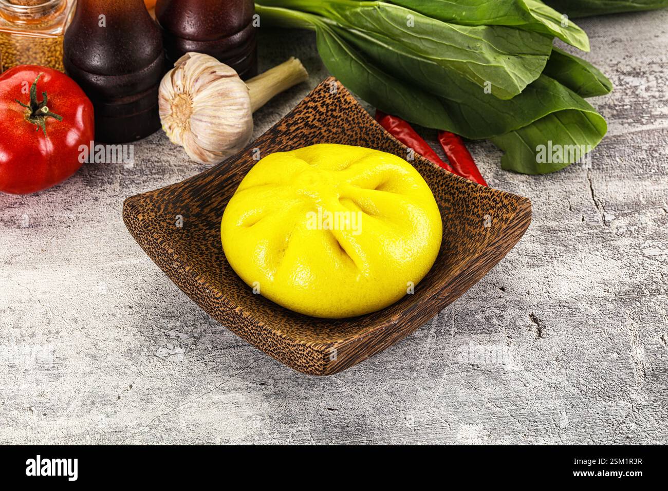 Asian stuffed steamed yellow Bun Bao Stock Photo - Alamy