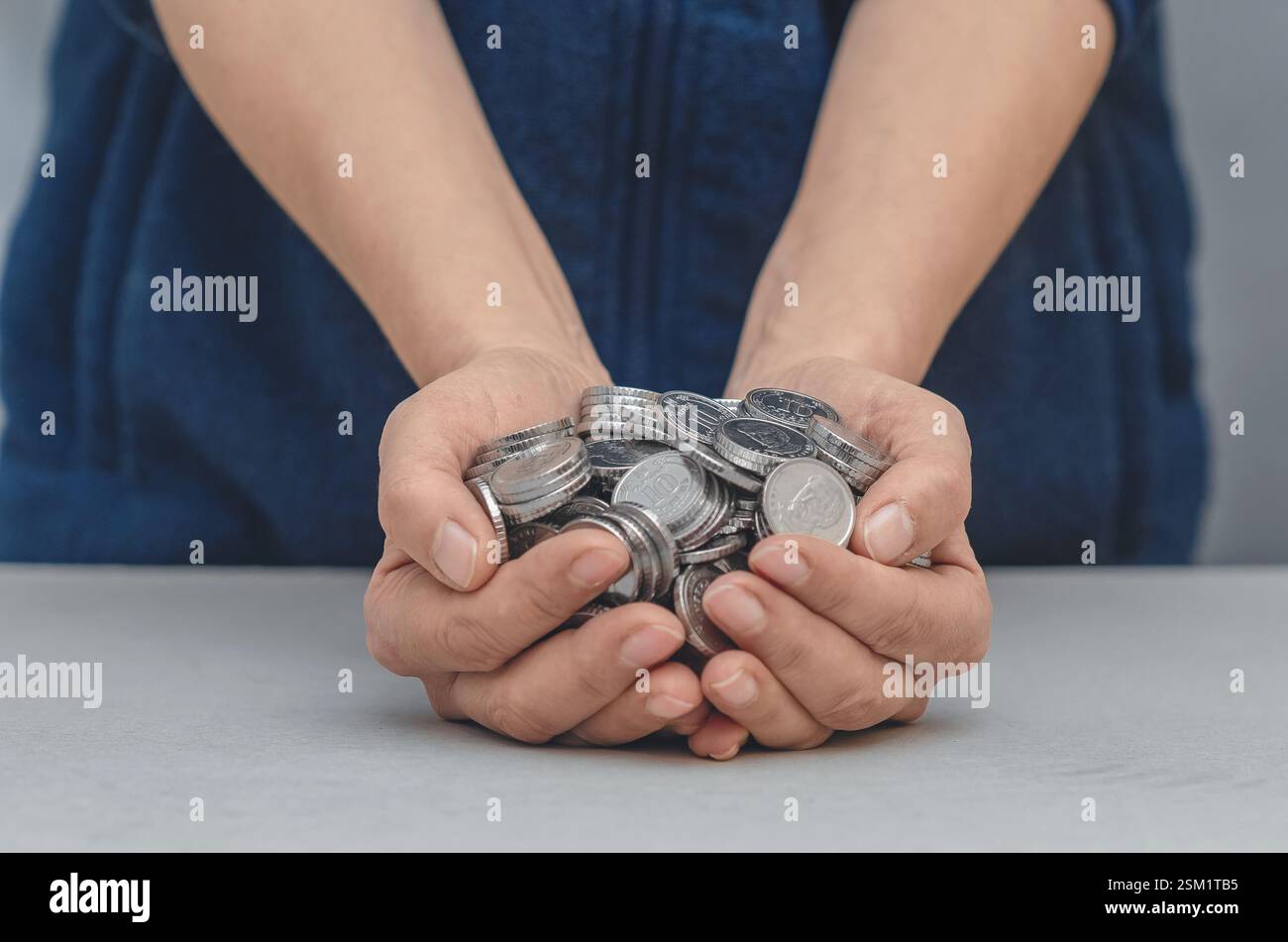 Silver coins in woman's hands on blurred background. Idea of importance ...