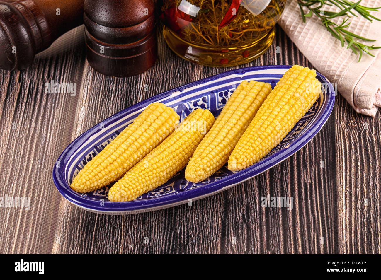 Canned baby mini corn cob in the plate Stock Photo - Alamy
