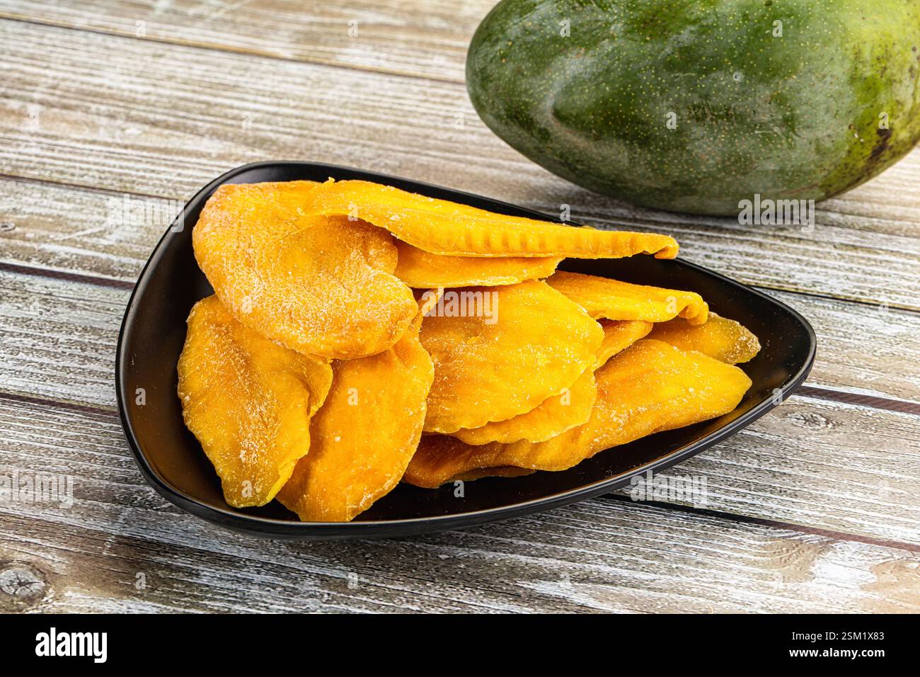 Dry sweet yellow mango snack in the plate Stock Photo - Alamy
