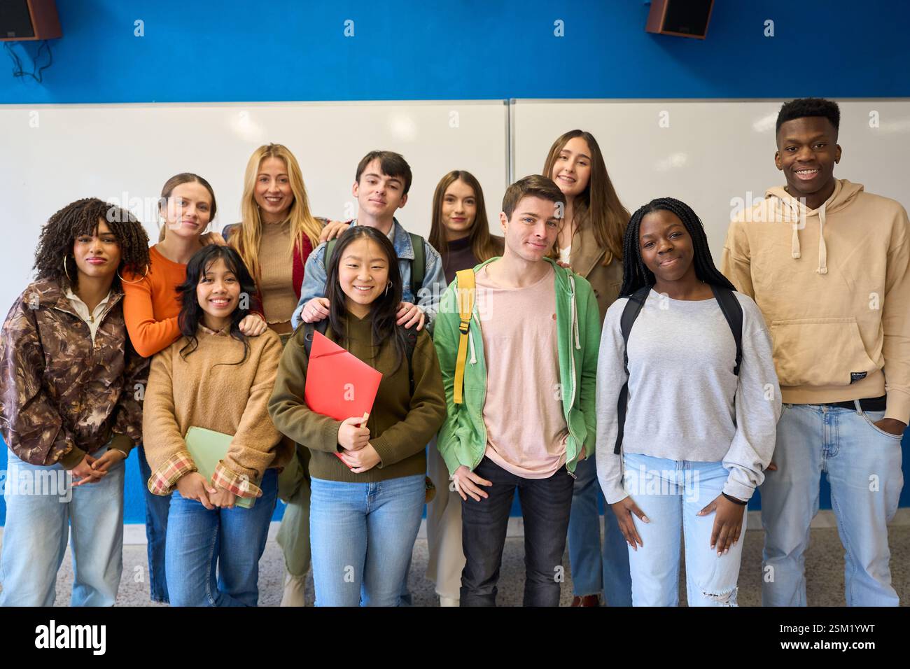 Diverse group of institute students posing together in classroom Stock ...