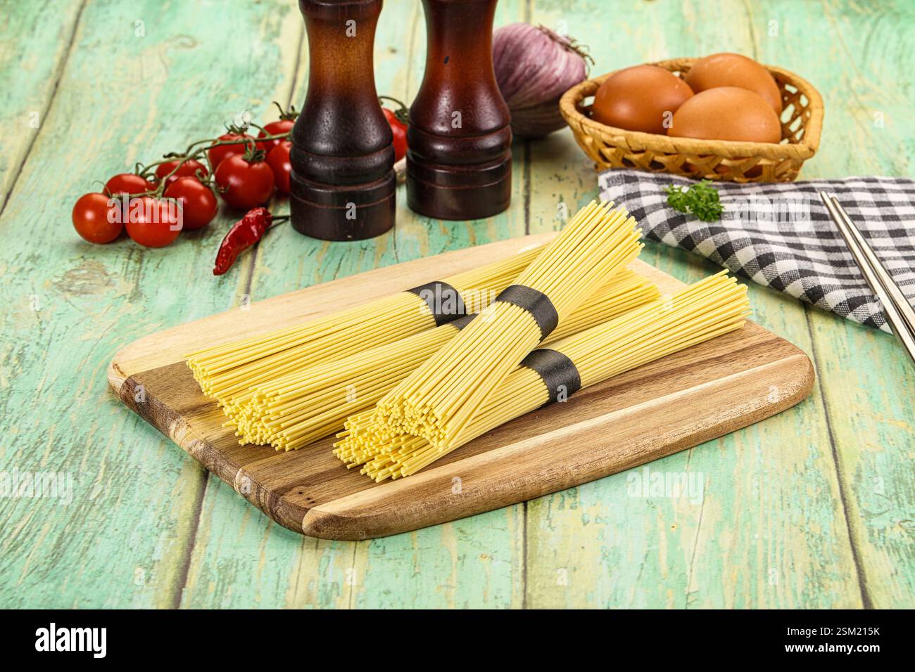 Raw dry uncooked yellow egg noodles Stock Photo - Alamy