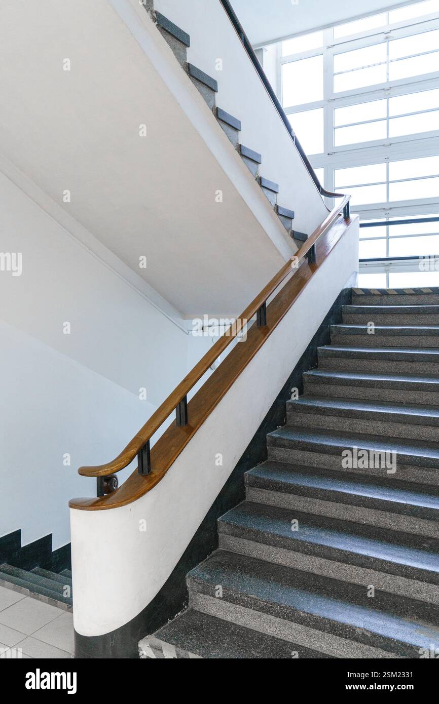 Interior of a modernist building with a beautiful white staircase ...