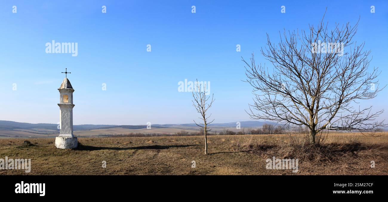 A typical saint's column on a path in the landscape of the Lower ...