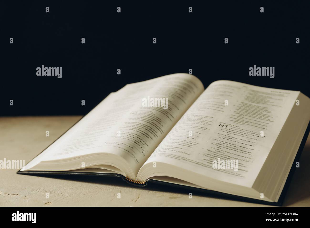 Open Holy Bible in English language on beige table Stock Photo - Alamy