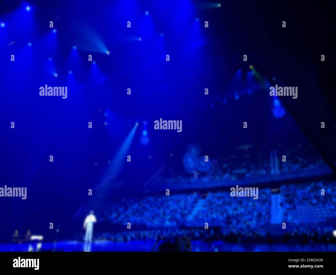 Singer performing on stage in front of audience indoors Stock Photo - Alamy