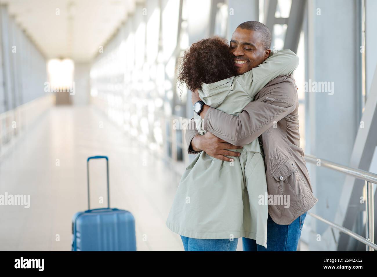 Romance At Arrival . African Couple Tenderly Embracing In Airport ...
