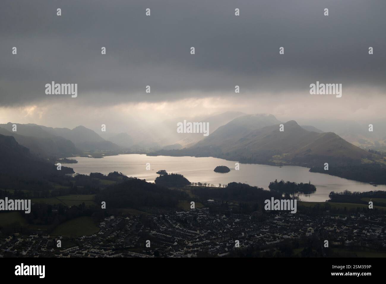 Dramatic landscape featuring a moody sky, dark storm clouds, and sun ...