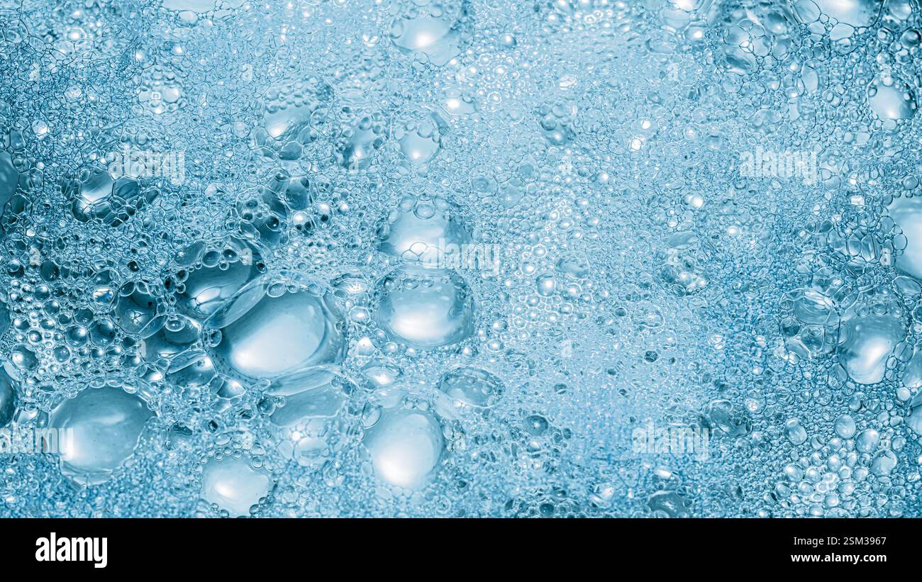 Foaming liquid soap texture. Blue bubbles background Stock Photo - Alamy