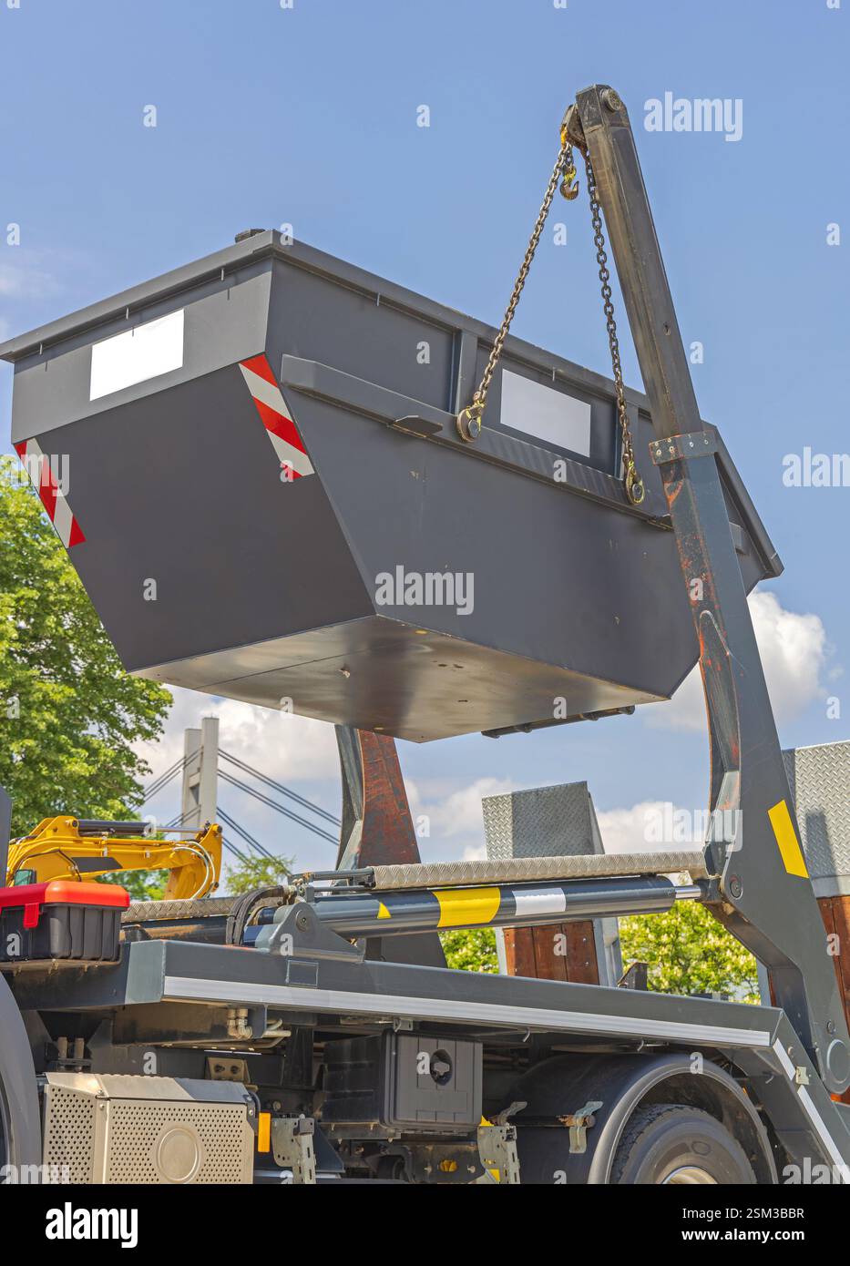 Extended Hydraulic Arms Lifting Skip Loader Truck Stock Photo - Alamy