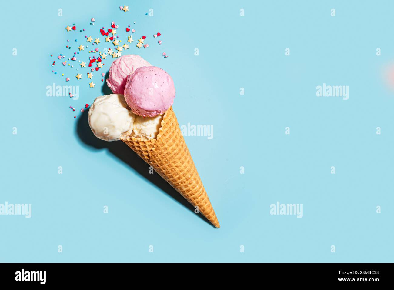 Ice cream waffle cone with vanilla and strawberry ice cream scoops and ...