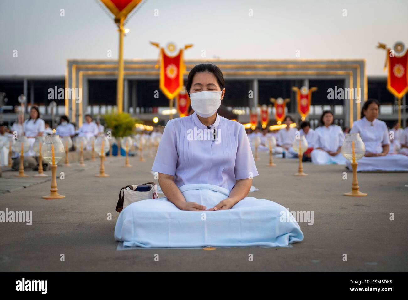 Khlong Luang, Pathum Thani, Thailand. 12th Feb, 2025. Worshippers sit ...