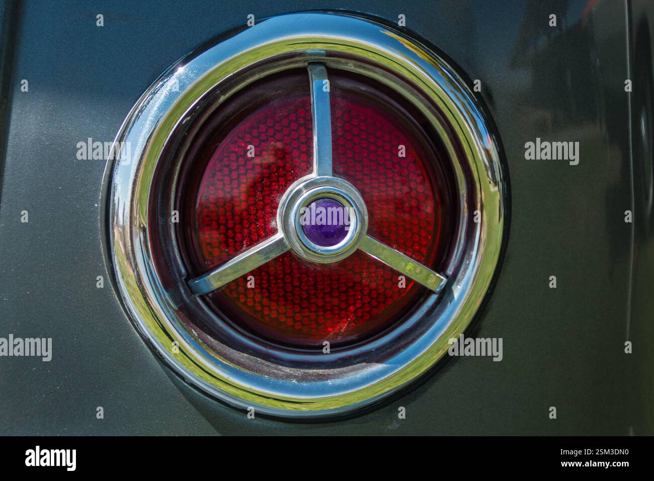 A vintage blue dot taillight lens on a classic car. The blue center dot ...