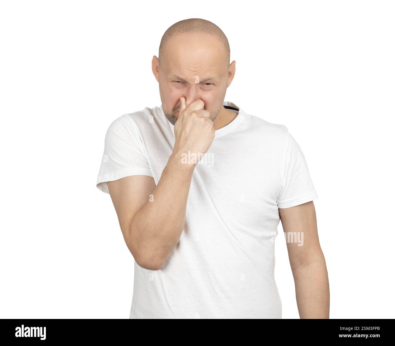 A bald man in a white t-shirt is pinching his nose with a disgusted ...