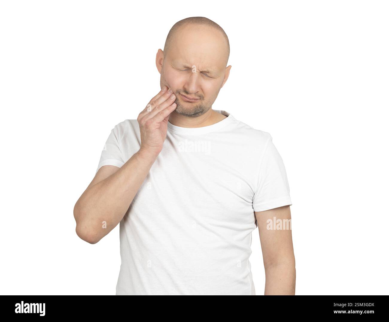 A bald Caucasian man in a white t-shirt stands against a neutral ...