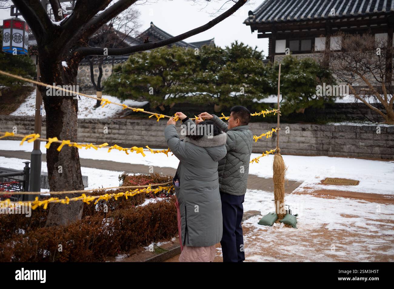 Participants engage in traditional customs to celebrate the first full ...
