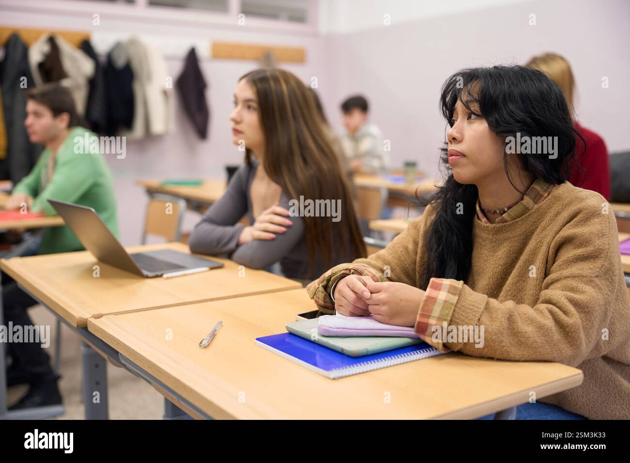 Students listening to teacher during lecture in classroom Stock Photo ...
