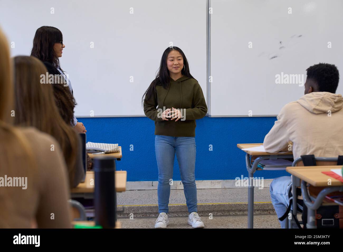 Young student presenting project in classroom at high school institute ...