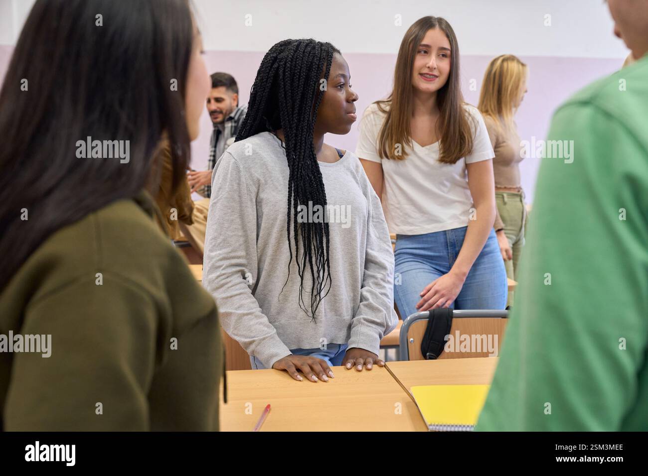 University students chatting together in classroom after lesson Stock ...