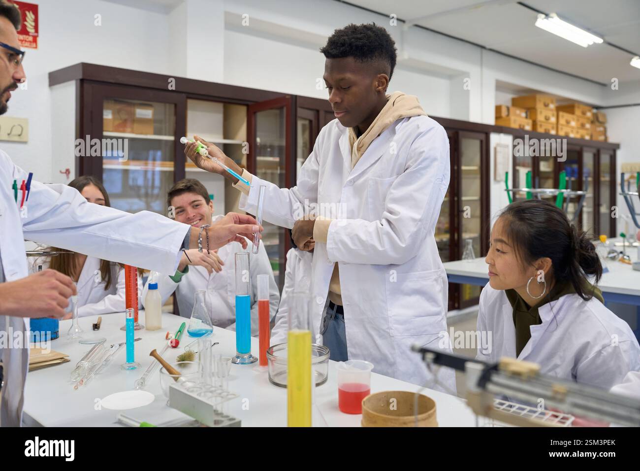 Students and teacher making experiments in chemistry laboratory Stock ...