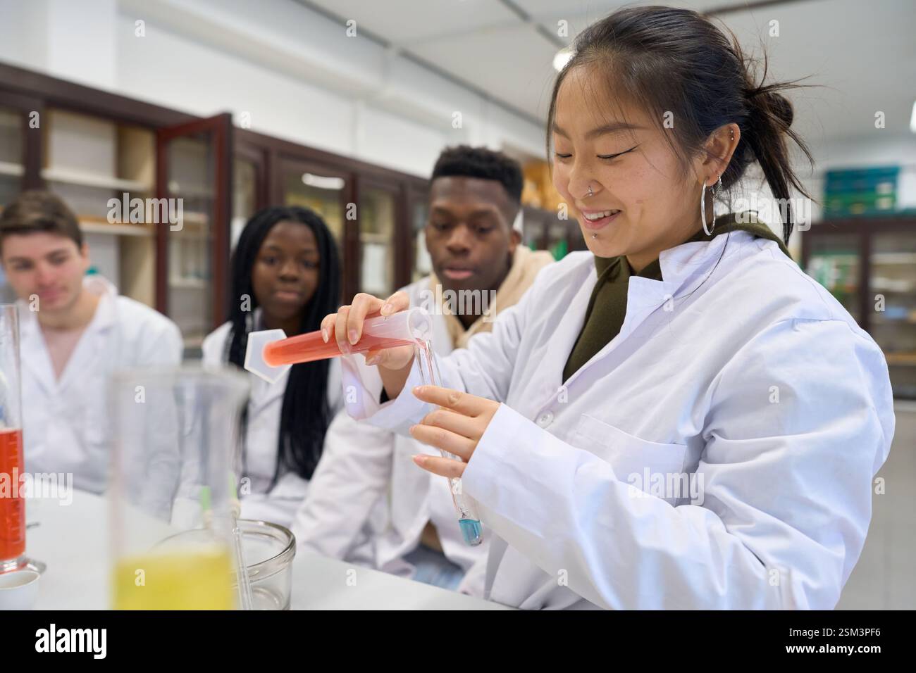 Group young people doing experiments hi-res stock photography and ...