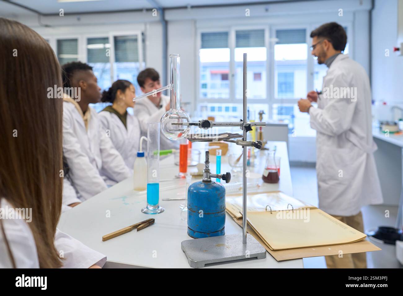 Chemistry teacher explaining lesson to students in laboratory Stock ...