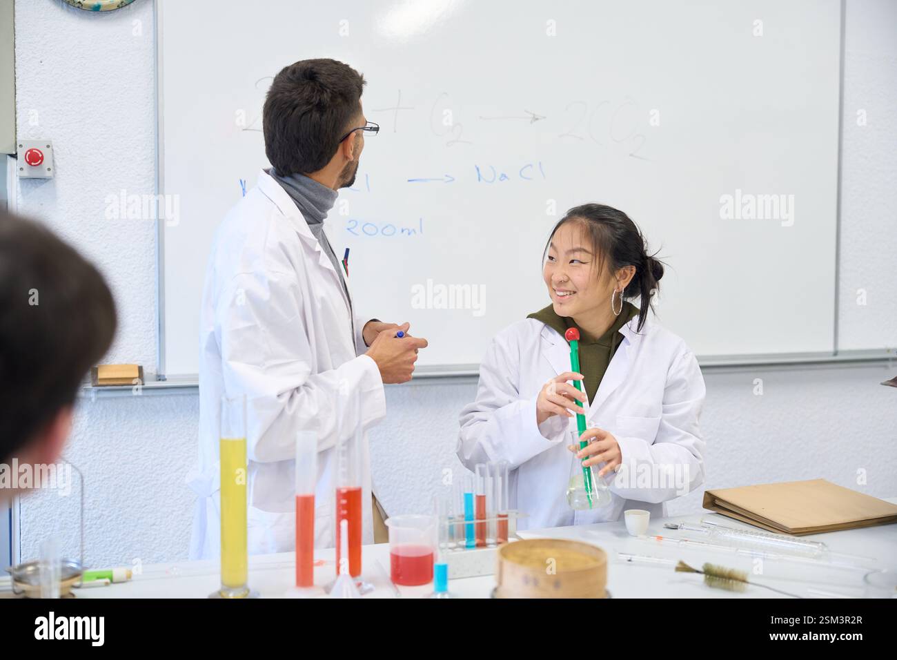 Chemistry students collaborating on experiment in university lab Stock ...