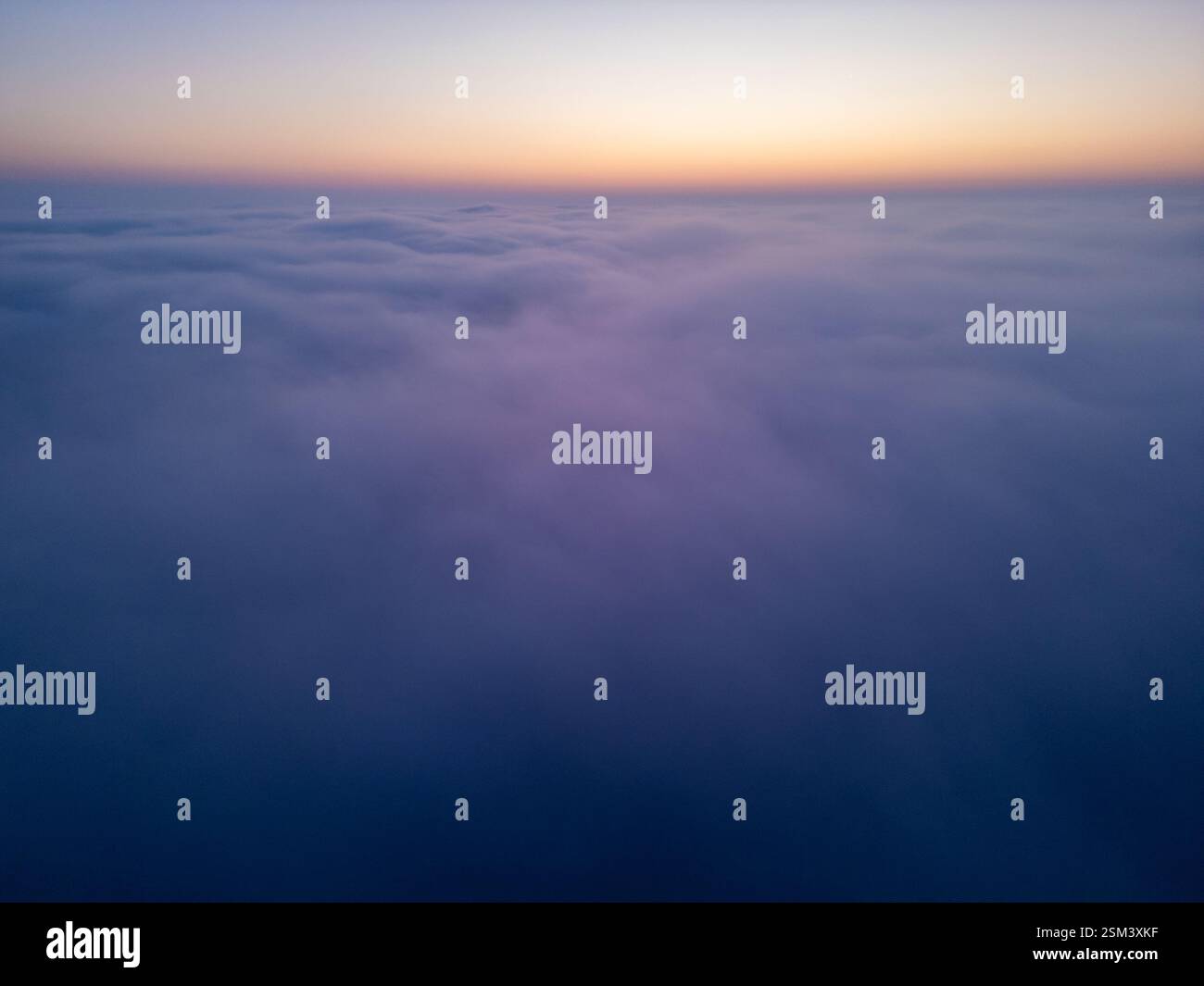 Aerial drone view above clouds at sunrise, high-altitude misty ...