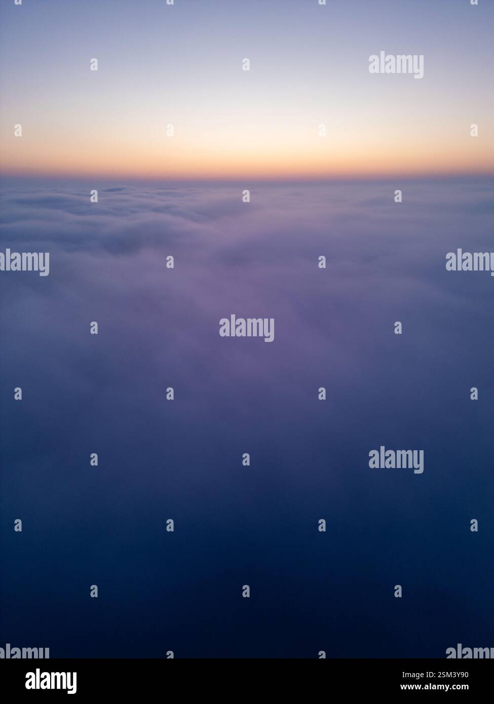 Aerial drone view above clouds at sunrise, high-altitude misty ...