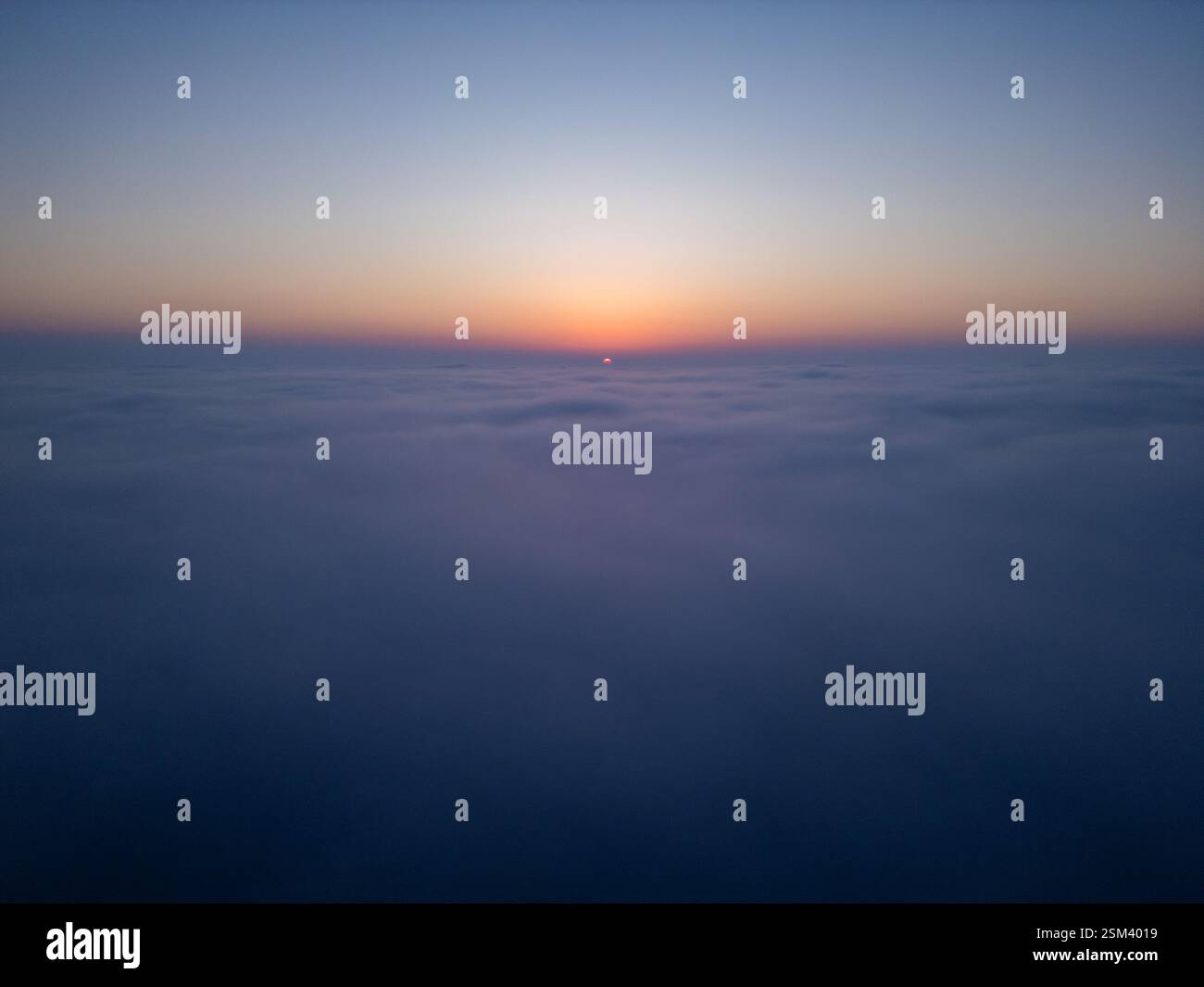 Aerial drone view above clouds at sunrise, high-altitude misty ...