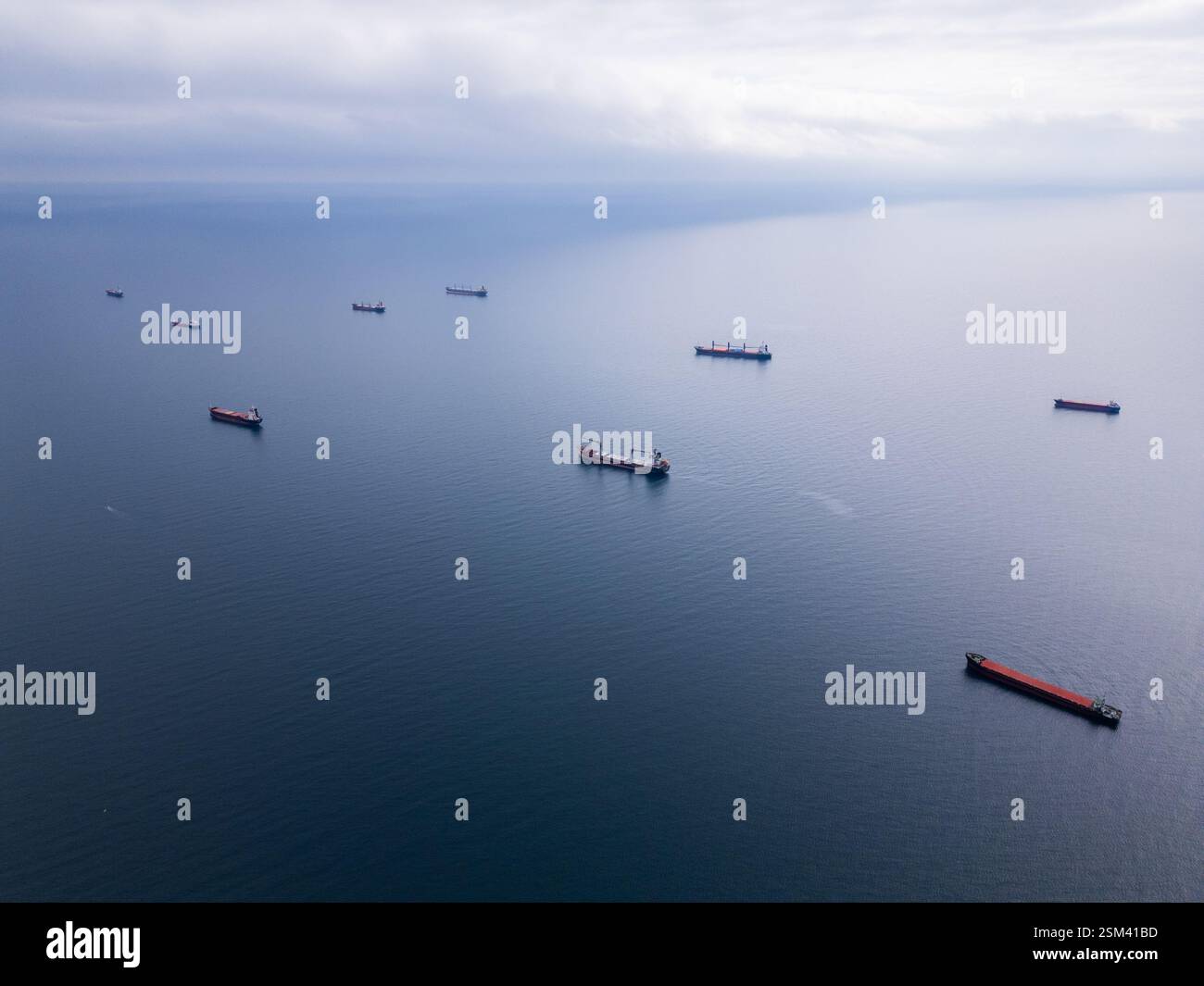An aerial perspective of cargo ships floating on the open sea ...