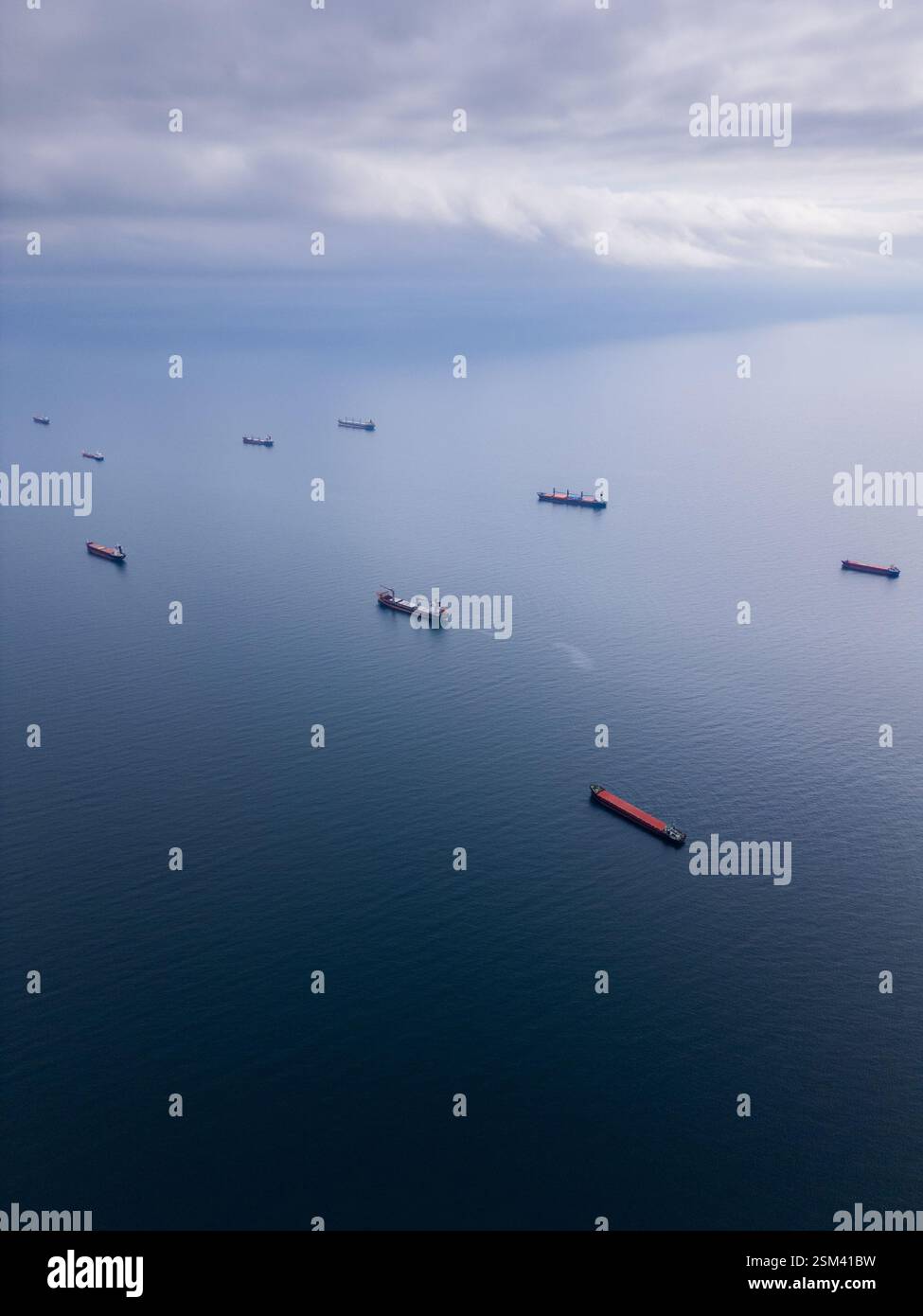 An aerial perspective of cargo ships floating on the open sea ...