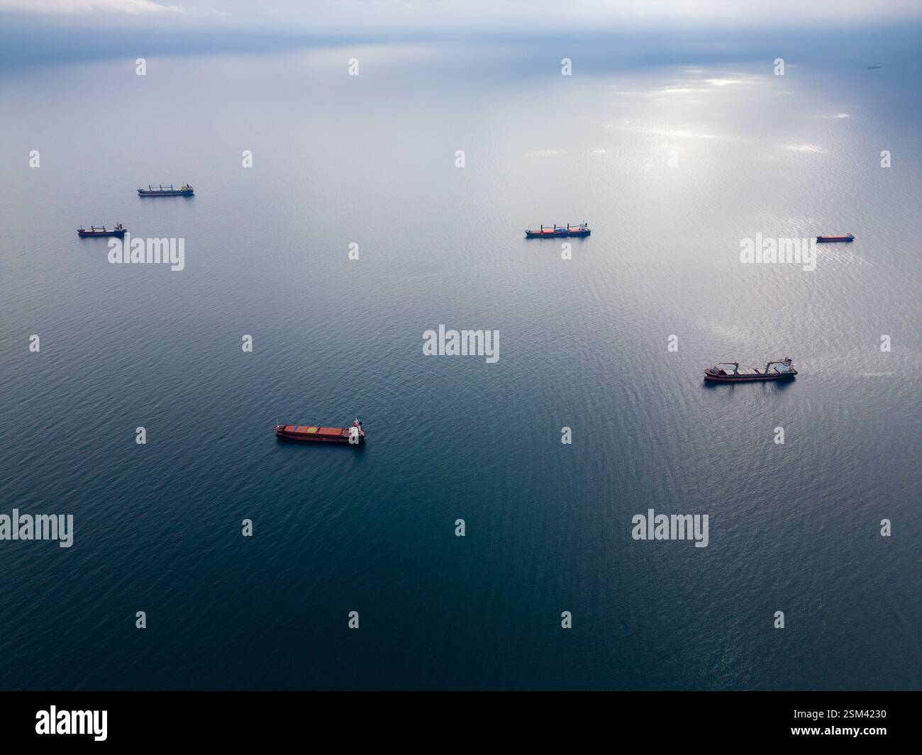 An aerial perspective of cargo ships floating on the open sea ...