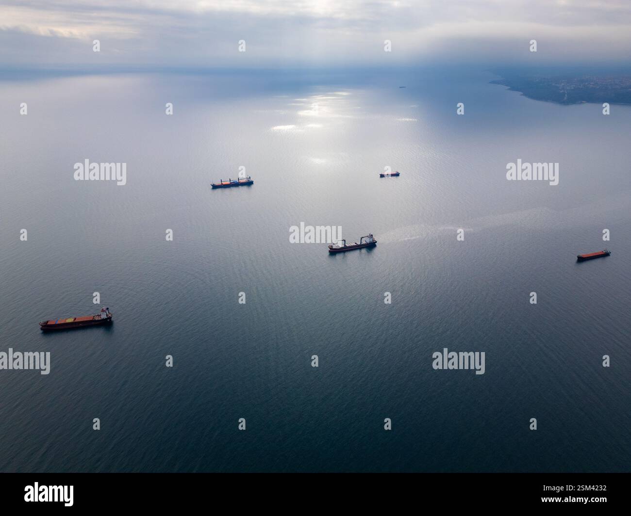 An aerial perspective of cargo ships floating on the open sea ...