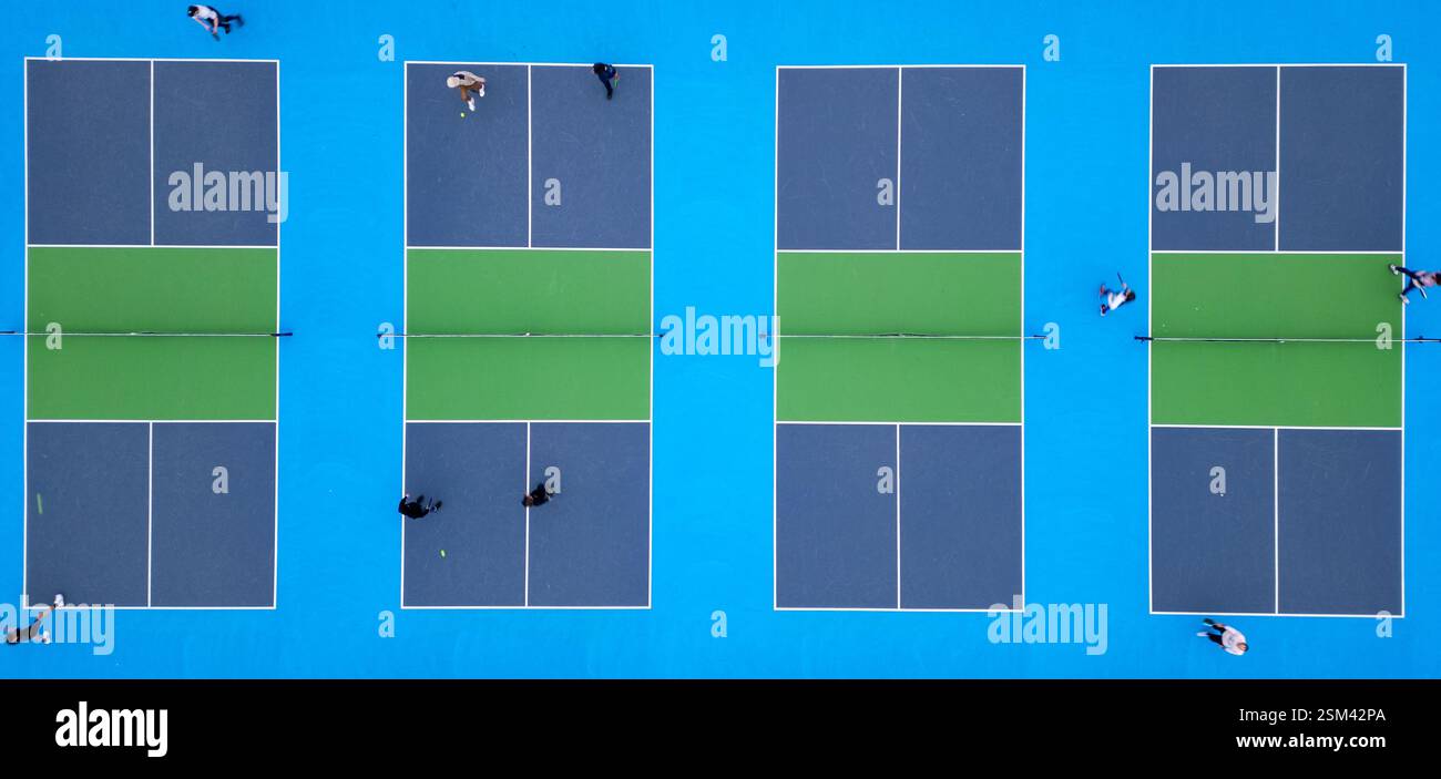 Aerial top-down view of multiple pickleball courts with players engaged ...