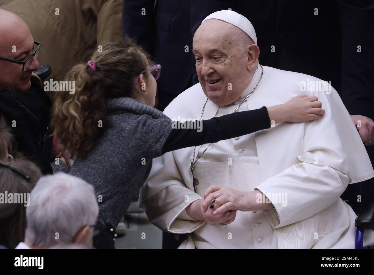 Vatican City State. 12th Feb, 2025. POPE FRANCIS gets a hug from a young girl during the ...