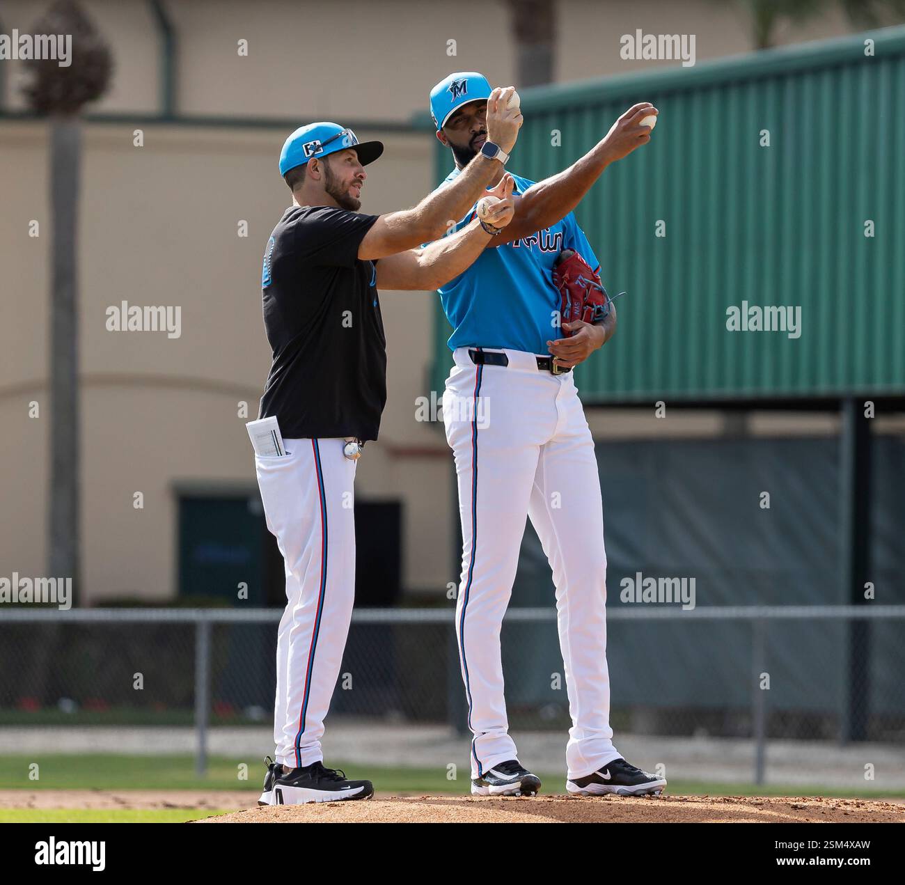 Miami Marlins pitcher Sandy Alcantara (22) talks with pitching coach ...