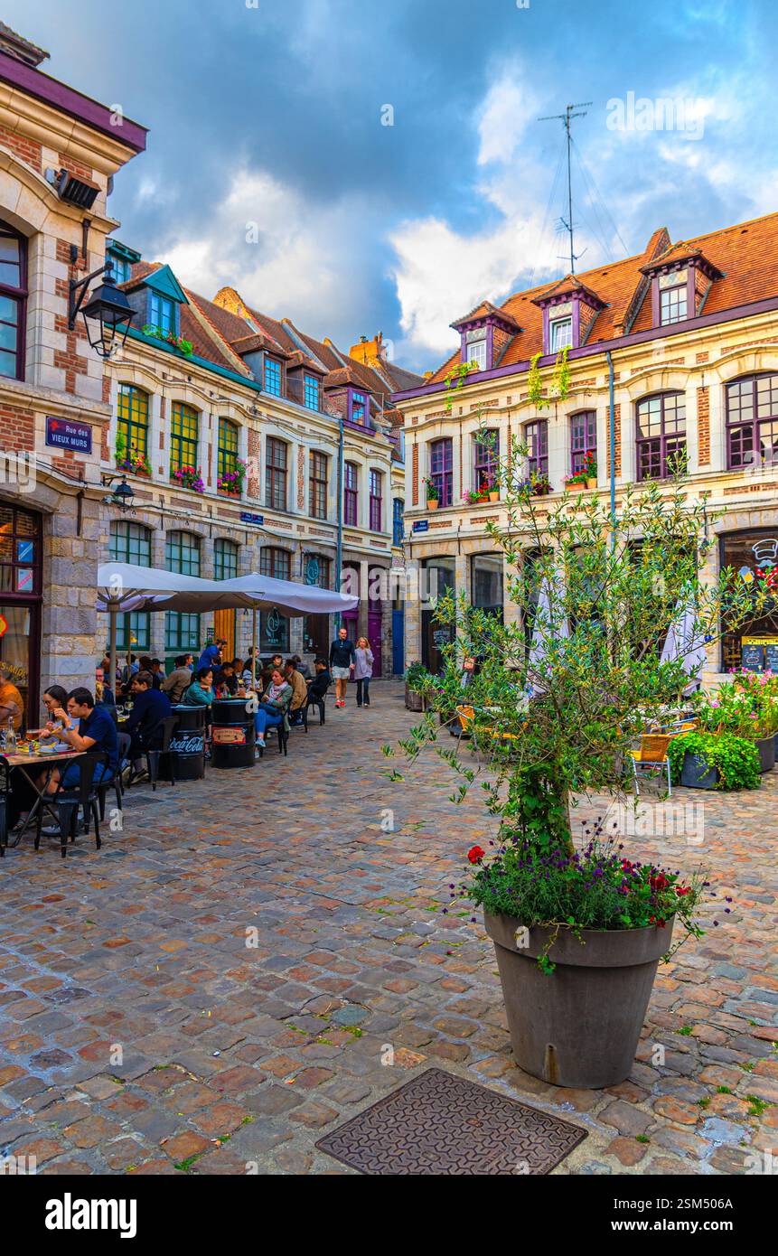 Lille, France, July 3, 2023: people sit in street restaurants in ...