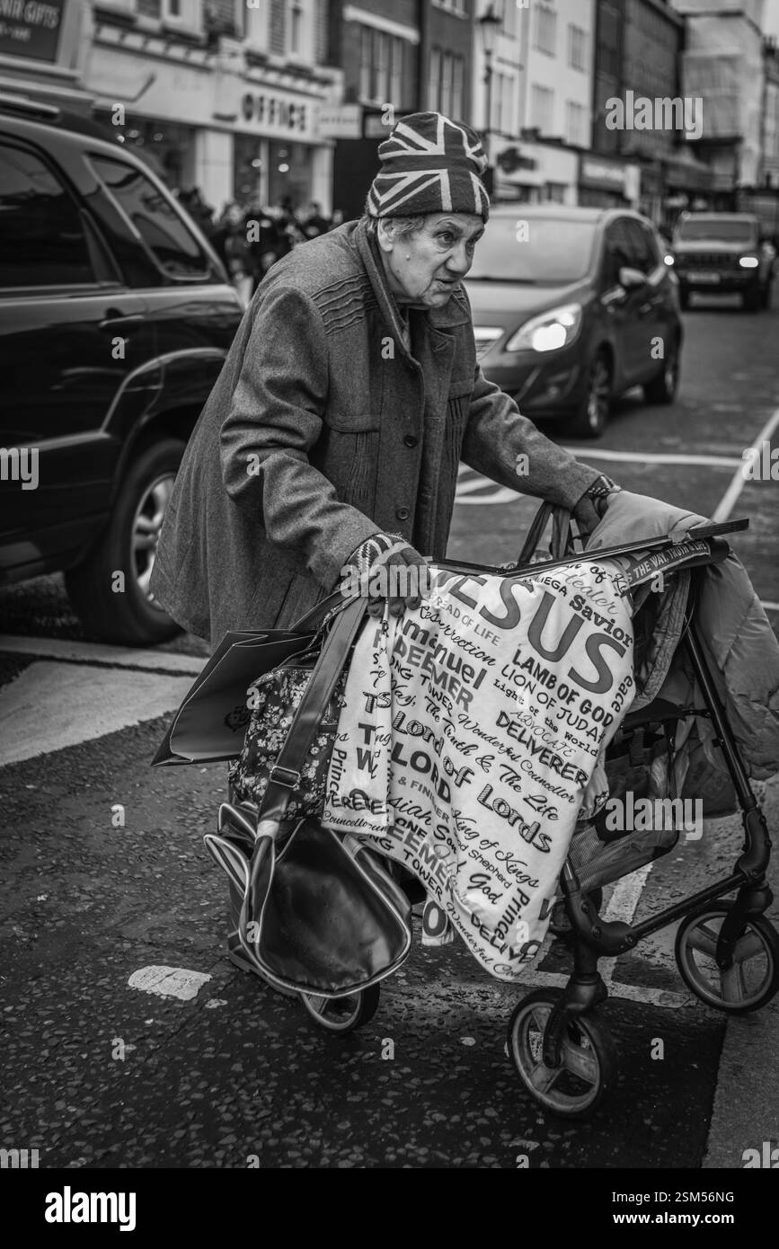 A christian octogenarian woman takes a stroll with the help of her ...