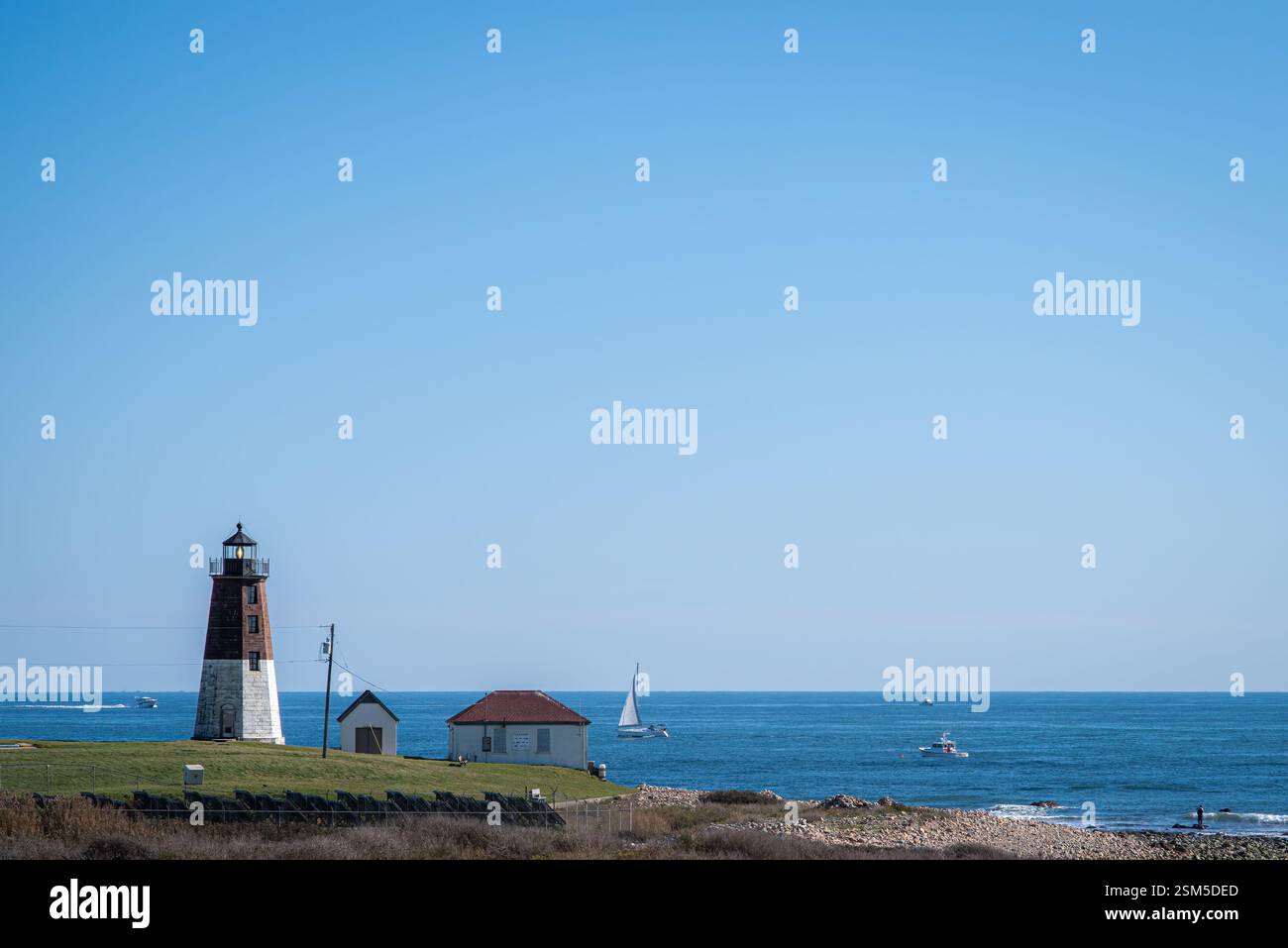 A scenic coastal view of a historic lighthouse near the ocean with ...