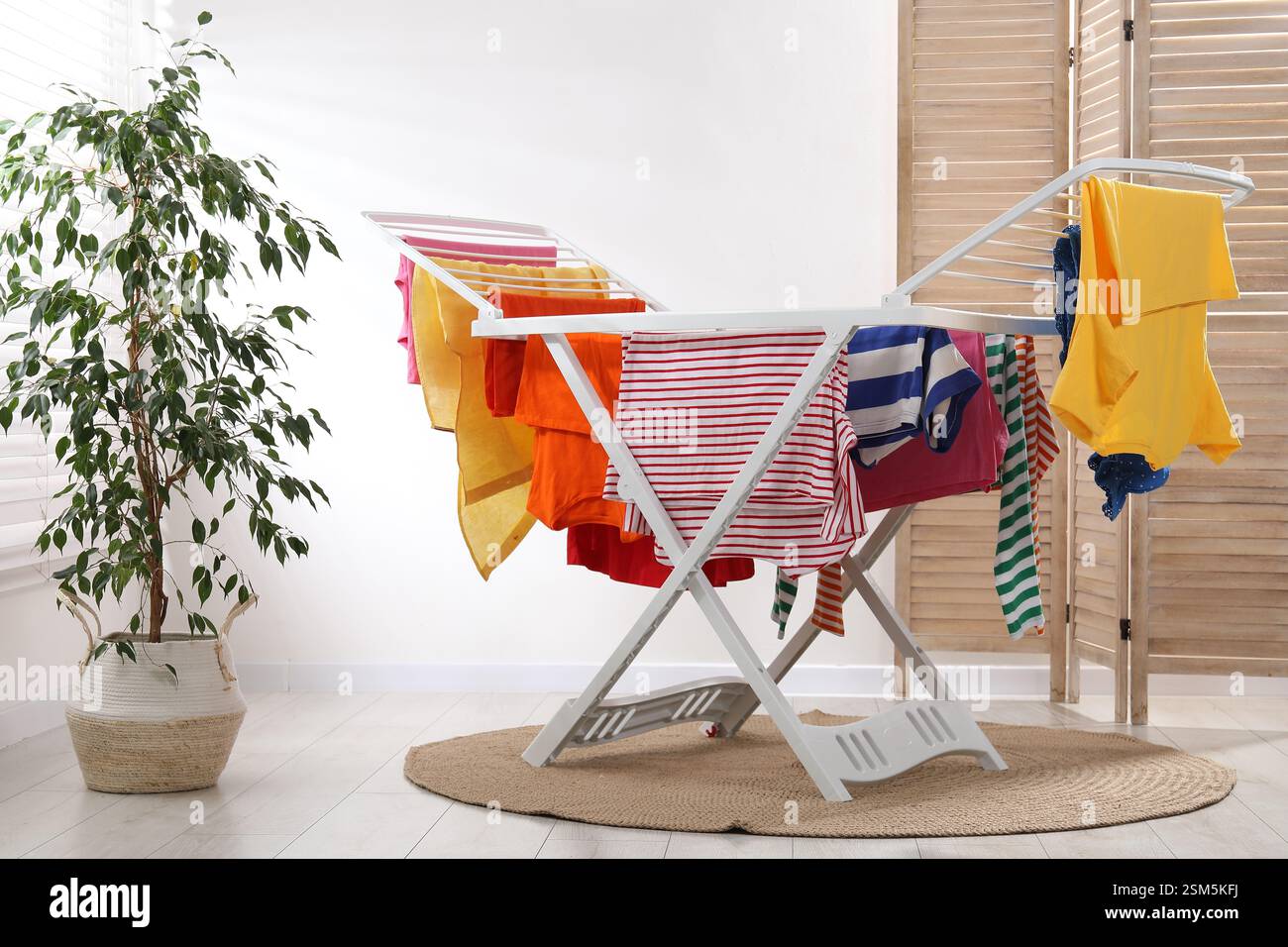 Drying rack with fresh clean laundry at home Stock Photo - Alamy