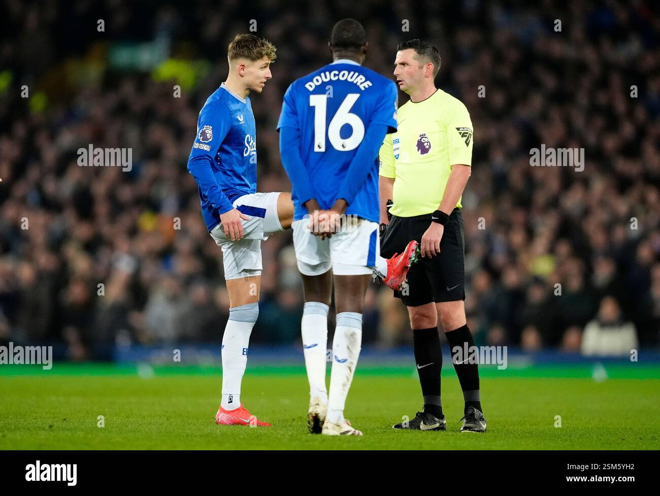 Everton's Jesper Lindstrom (left) speaks to referee Michael Oliver ...