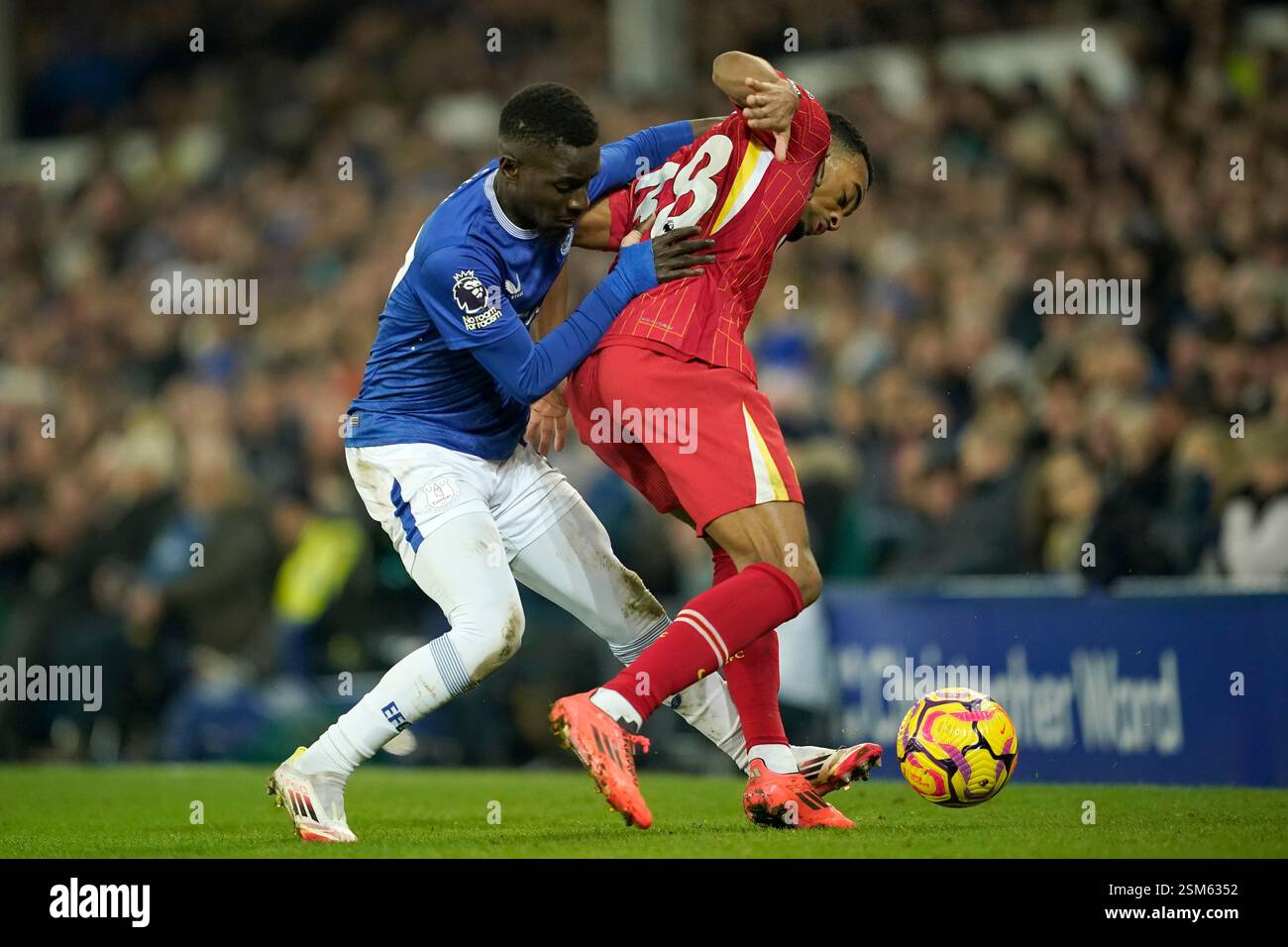 Everton's Idrissa Gueye, left, challenges for the ball with Liverpool's ...