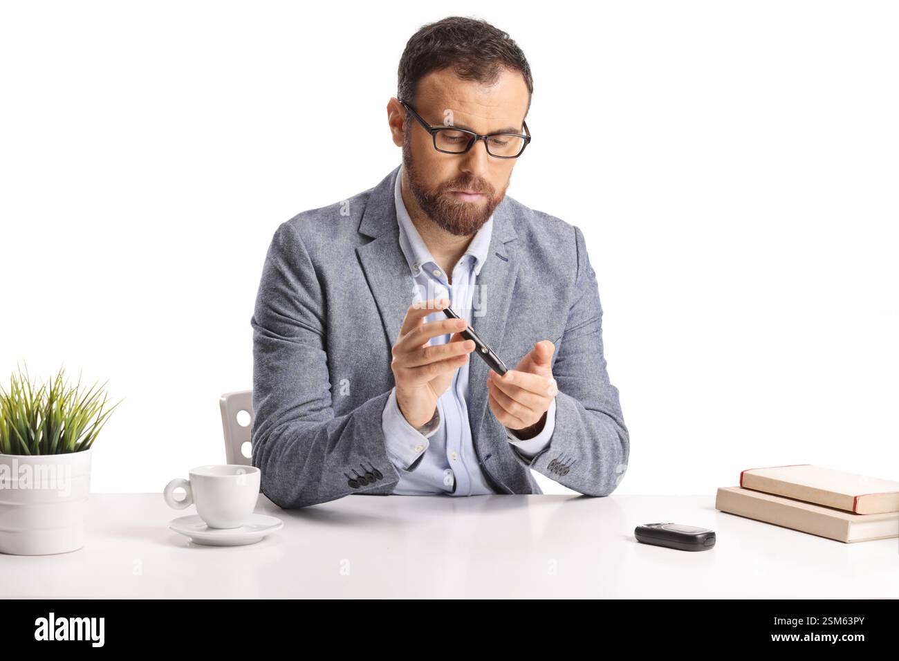 Man using a lancing device for blood glucose monitoring isolated on ...