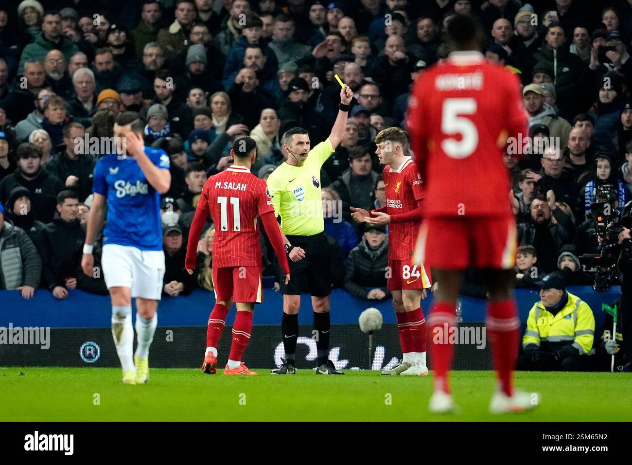 Liverpool's Conor Bradley is shown a yellow card by referee Michael ...