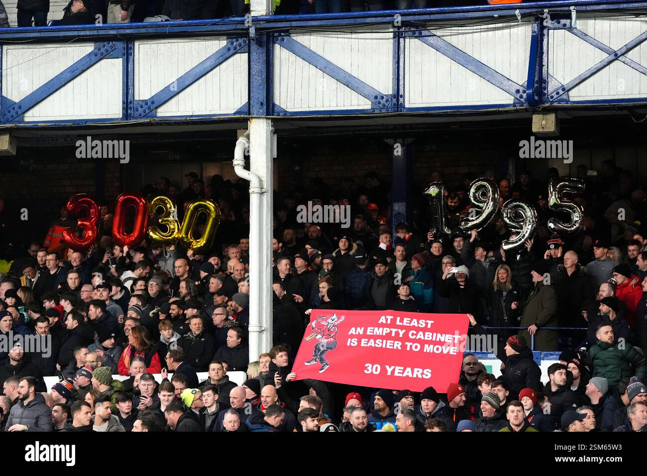 Liverpool fans in the away stand with various balloons and banners ...