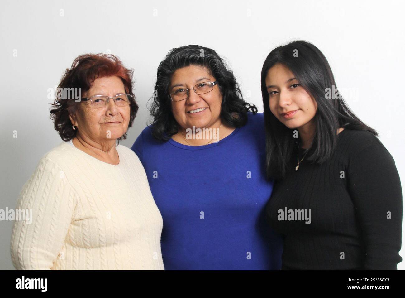 Three generations of brown Latina women, grandmother, mom and daughter ...