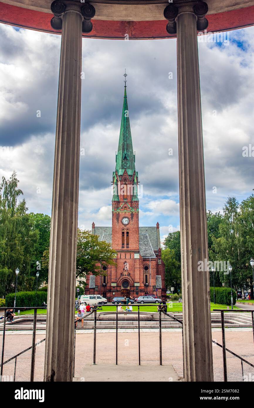 Visitors enjoy a serene moment at the park, framed by elegant columns ...