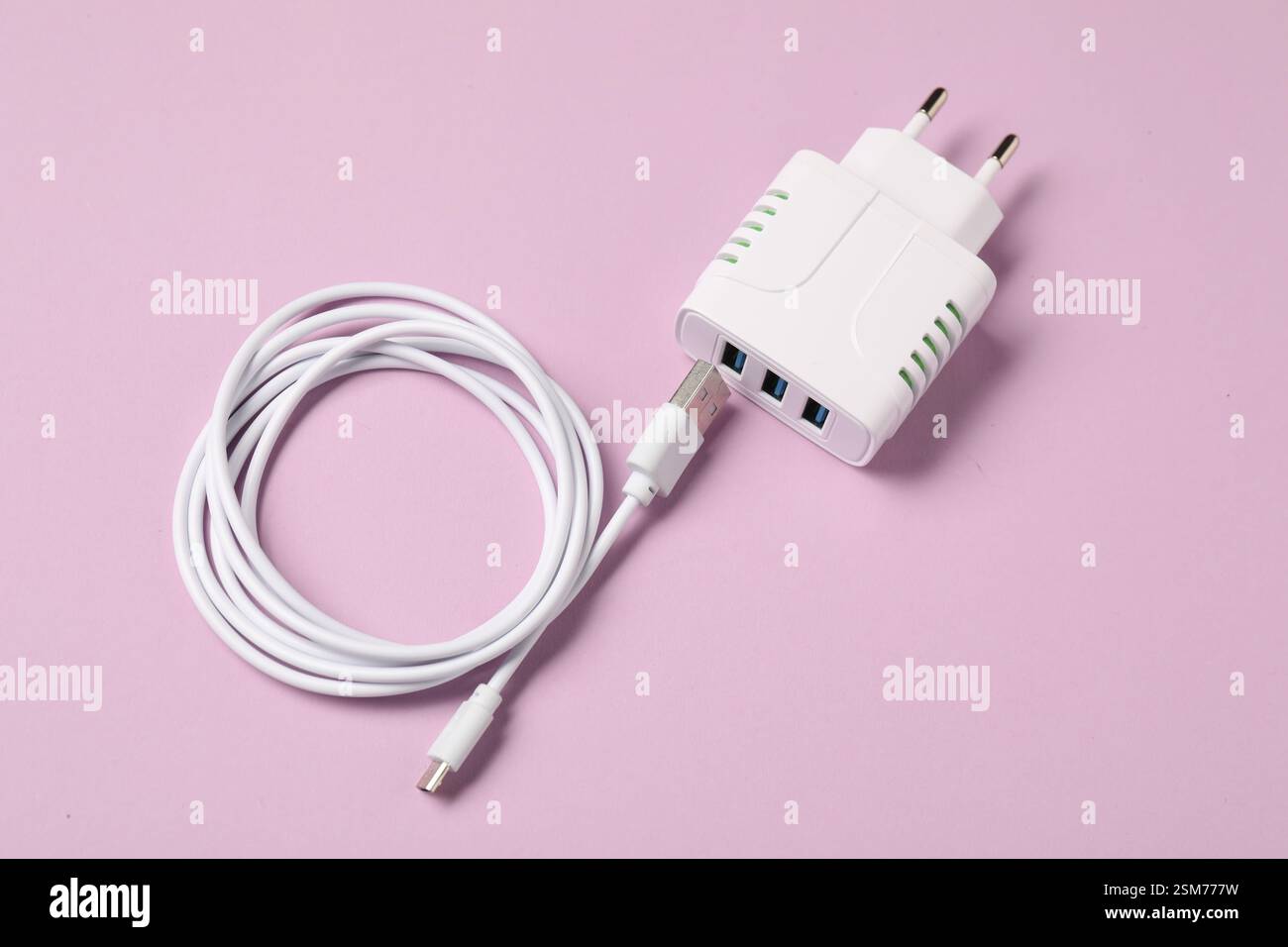 USB power adapter and charge cable on pink background, above view Stock ...