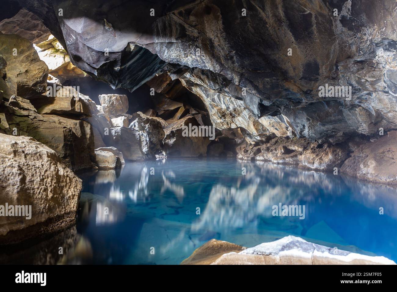 Grjotagja, a small lava cave with crystal blue hot water spring and ...